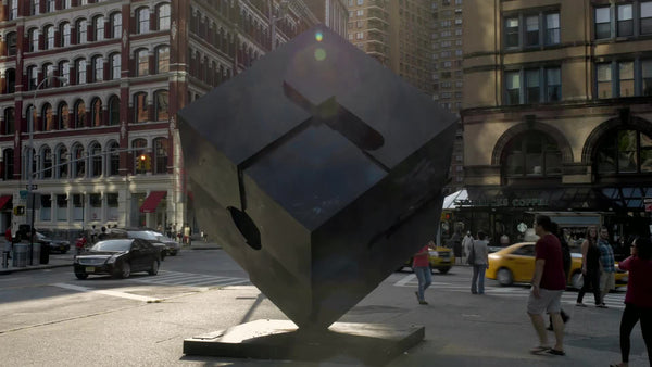kid pushing famous cube sculpture in Cooper Square - guy spinning art ...